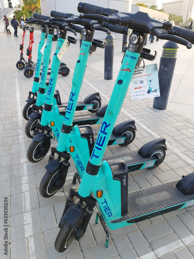 Dubai - September 22, 2022: Many electric scooters are parked on a ...