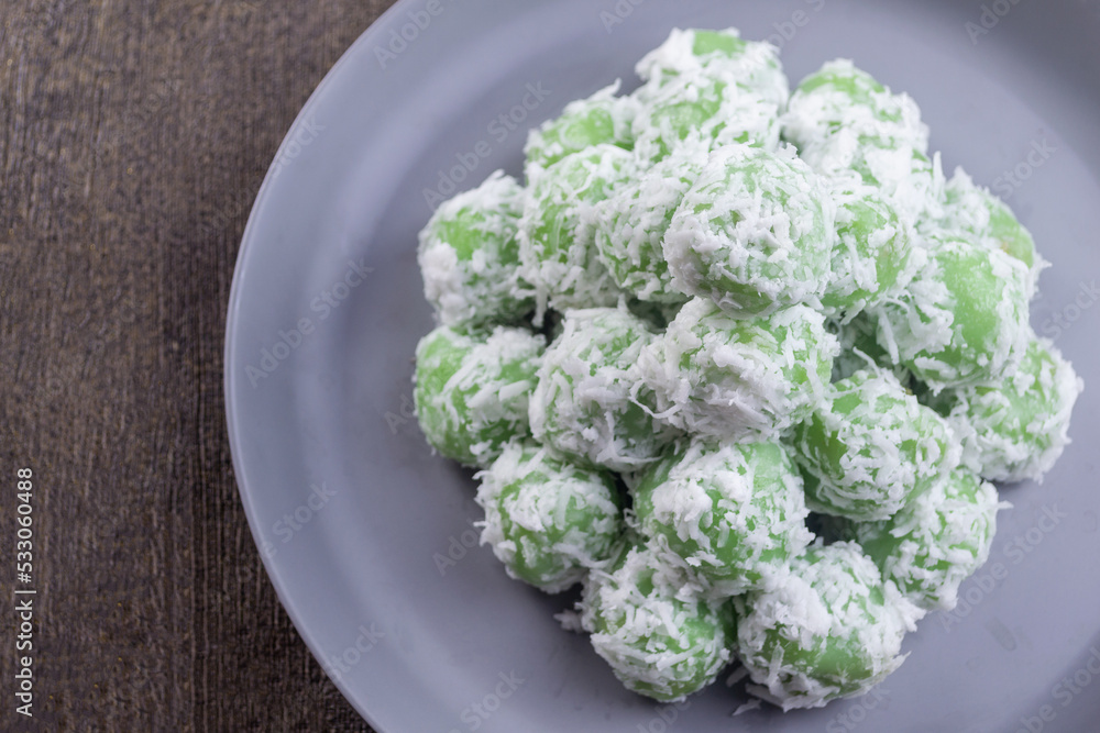 Klepon pandan is a snack of sweet rice cake balls filled with molten ...
