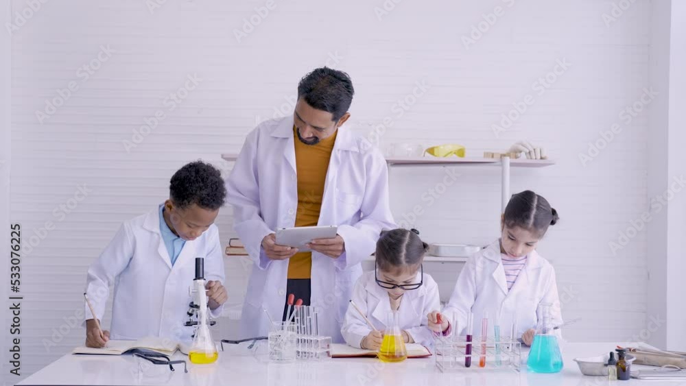 4K, In a school science lab, children are learning about mixing colors ...