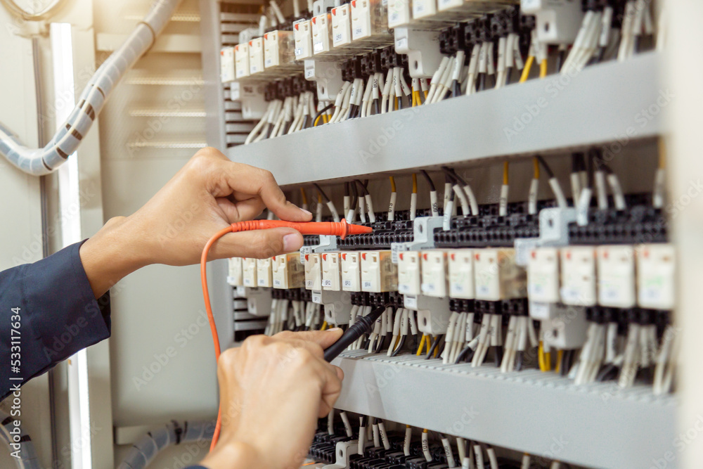 Electrical engineer using measuring equipment to checking electric ...
