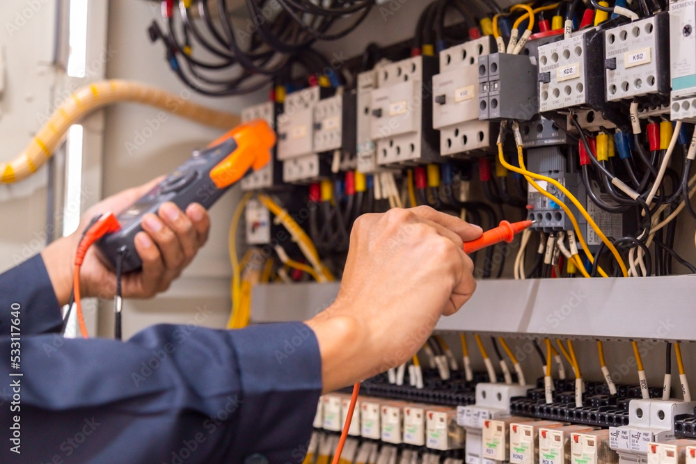 Electrical engineer using measuring equipment to checking electric ...