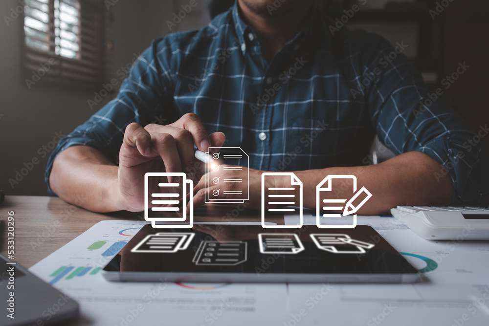 Businessman signs an electronic document on tablet management online documentation database ...