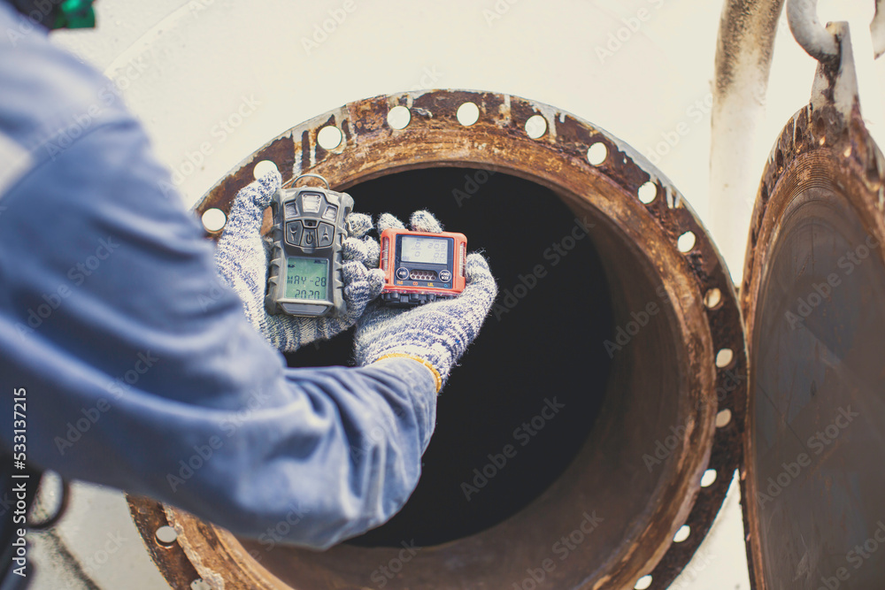 Worker hand holding gas detector inspection safety gas testing at front ...