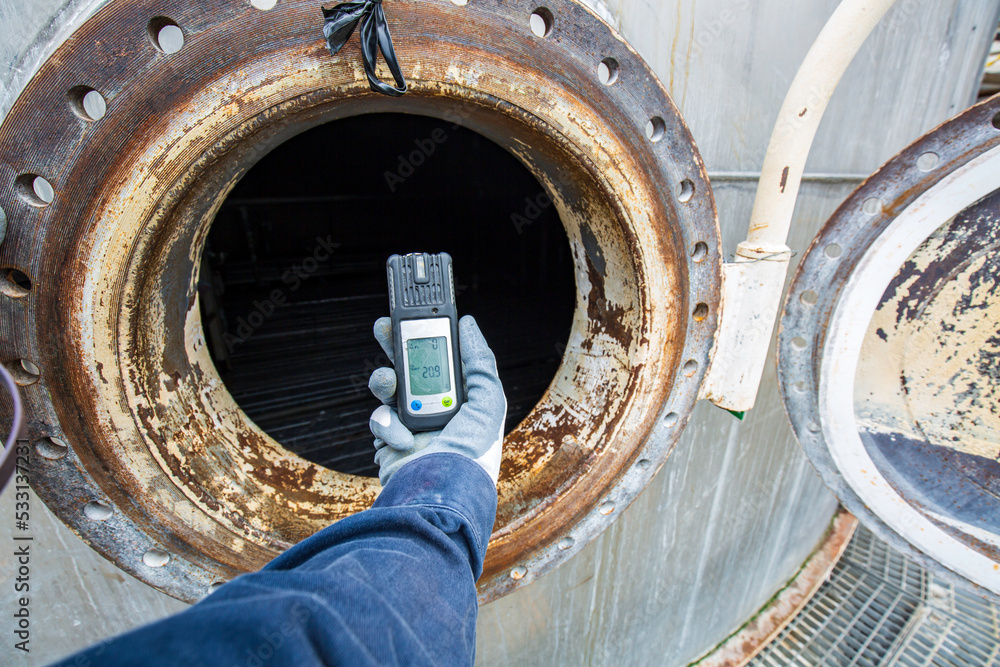 Worker hand holding gas detector inspection safety gas testing at front ...