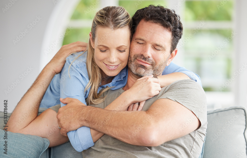 Couple, love and hug with a man and woman hugging in the living room of ...