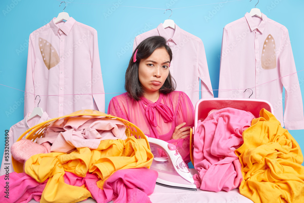 Housework laundry and housekeeping concept. Displeased brunette Asian ...