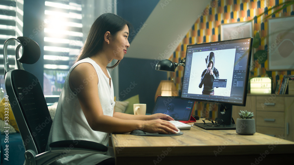 Asian woman creating 3D model of video game character in professional ...