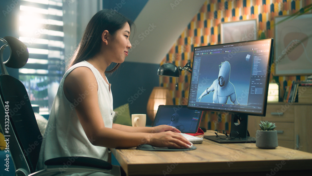 Asian woman creating 3D model of video game character in professional ...