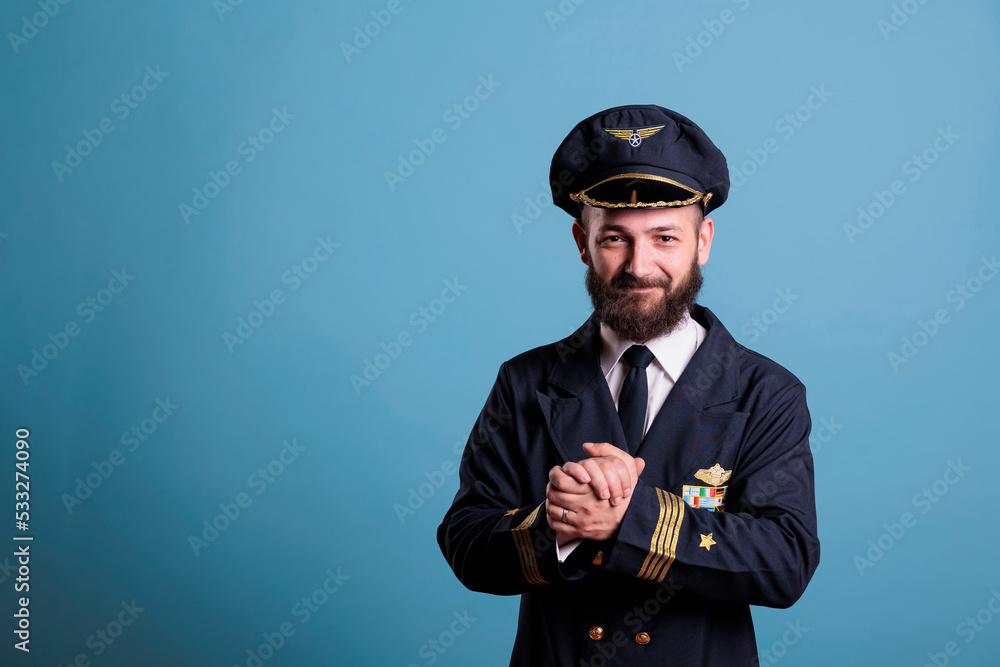 Smiling excited plane aviator in professional uniform clapping hands ...