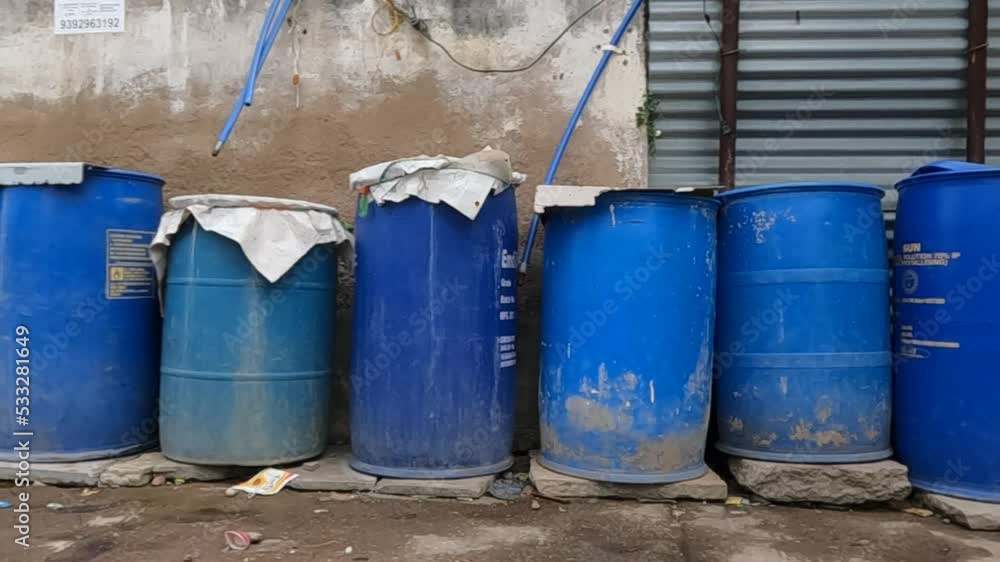 Blue color containers filled with water in slums, Drinking water in ...