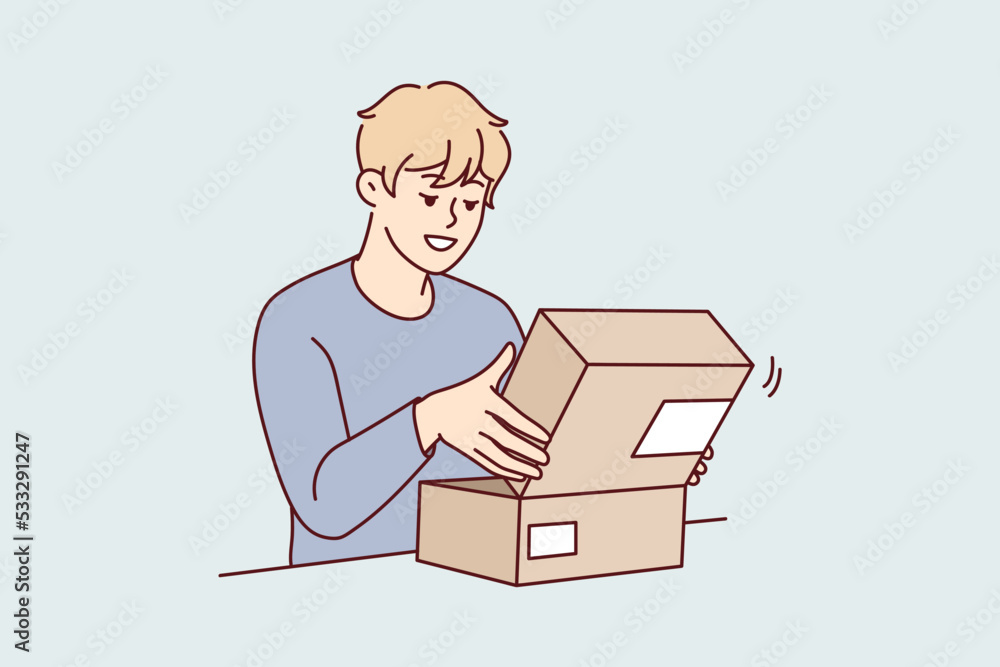 Excited young man open cardboard box shopping online. Smiling male ...