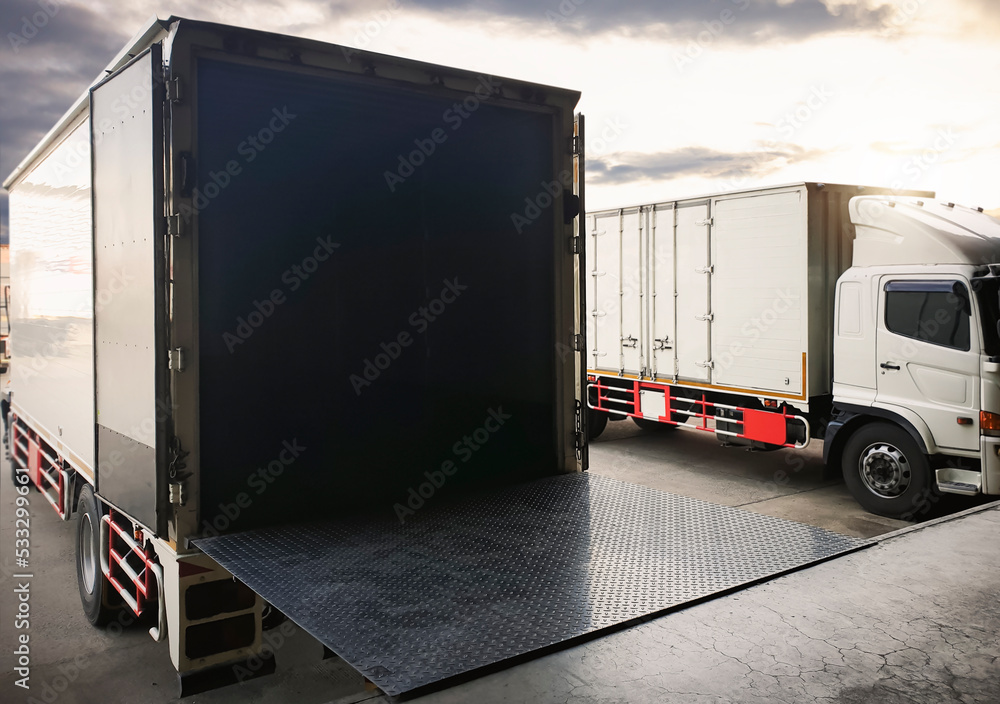 Cargo Contaner Trucks Parked Loading at Dock Warehouse. Shipping Cargo ...