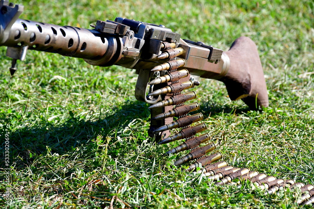A close up on a replica of an old WWII machine gun attached to a metal ...