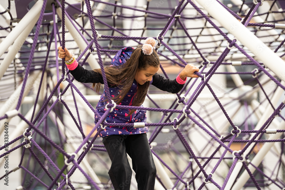 Cute teenage girl in the rope labyrinth kid park attraction Stock Photo ...