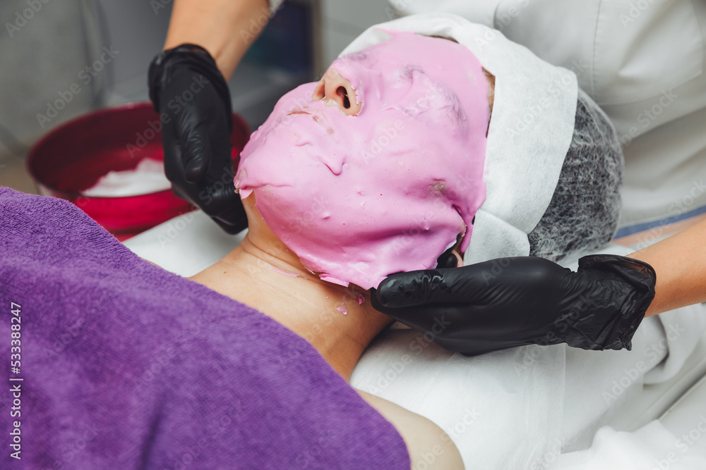 The process of removing the alginate mask from a woman's face. Facial ...
