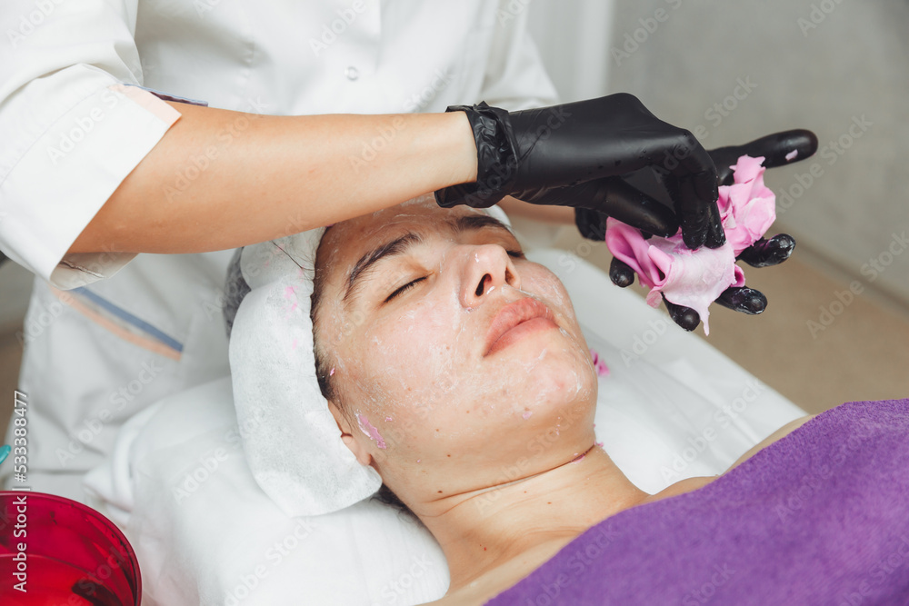 The process of removing the alginate mask from a woman's face. Facial ...