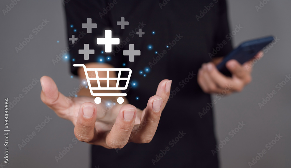 Man hand holding smartphone and shopping cart on top of hands with a ...