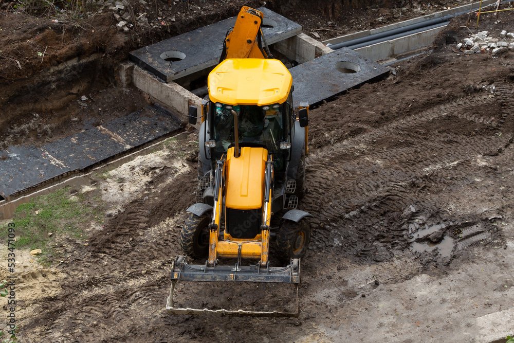 Earthwork excavator-bulldozer at a construction site. The work of a ...