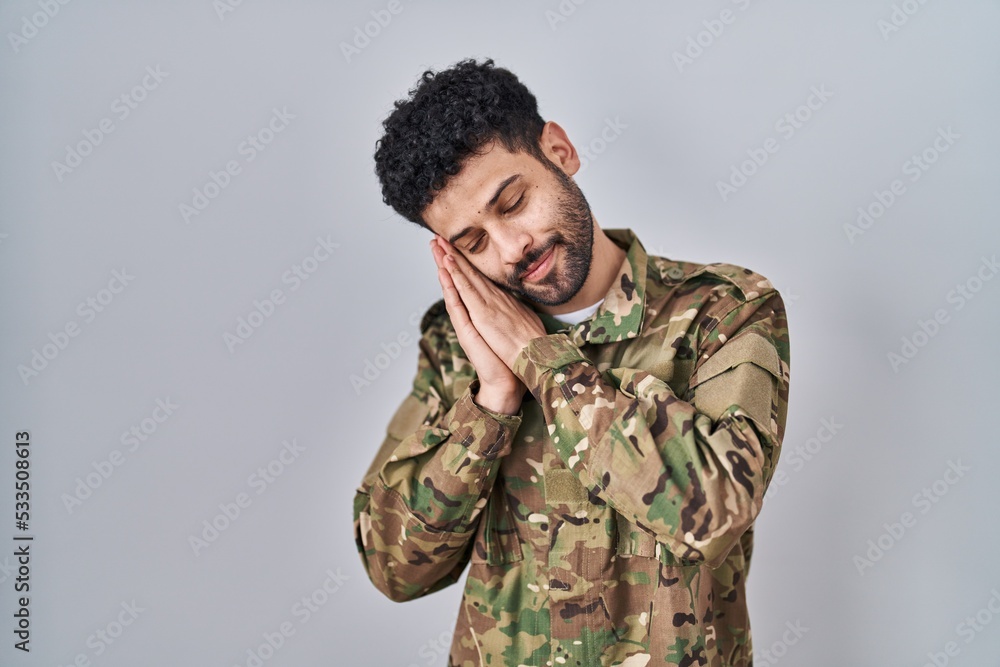 Arab man wearing camouflage army uniform sleeping tired dreaming and ...