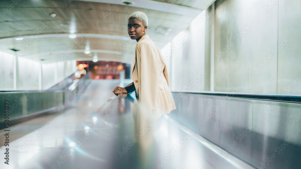 Reflective portrait of a charming young black lady in a bright coat ...