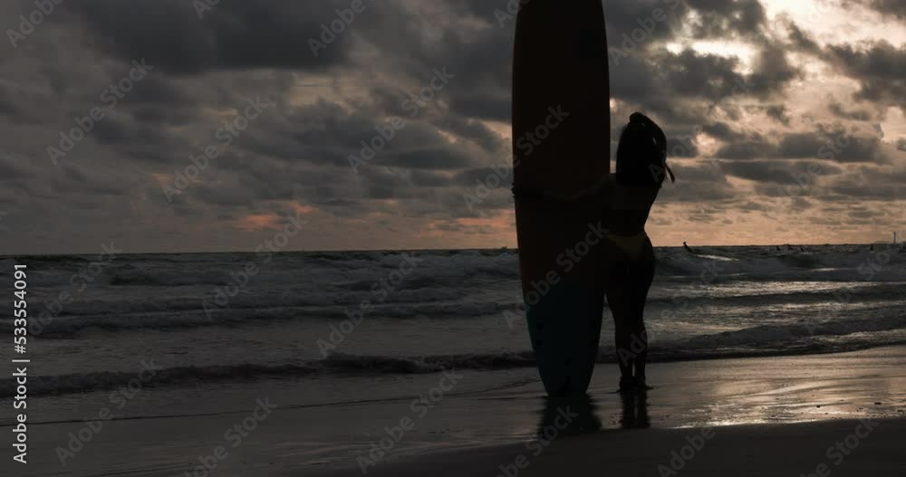 SLOW MOTION footage and silhouette young woman in bikini holding ...