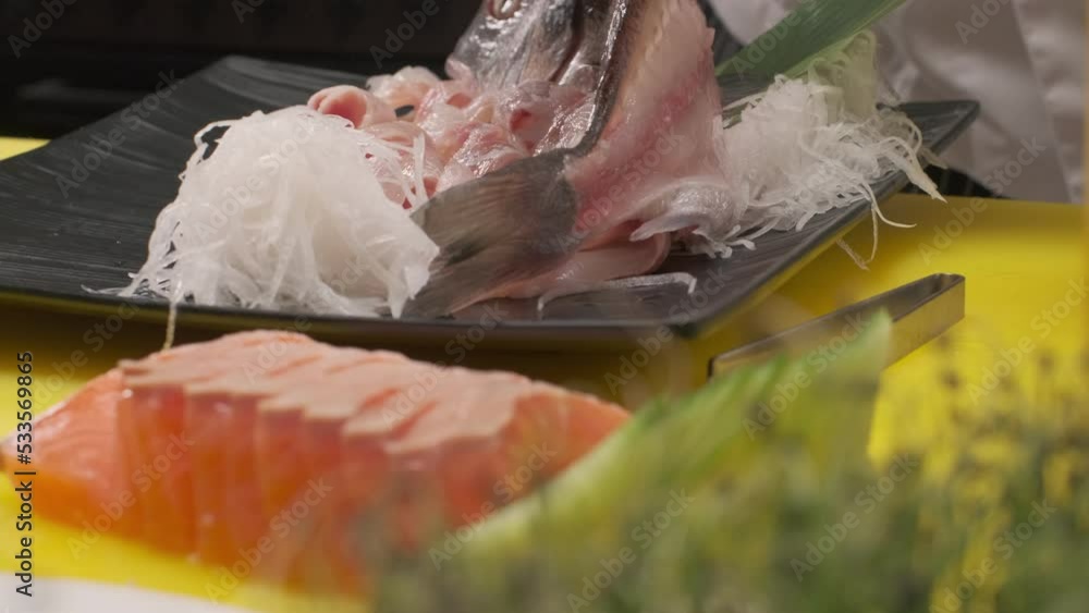 Making sushi with daikon, leaves and cut fish Stock Video | Adobe Stock