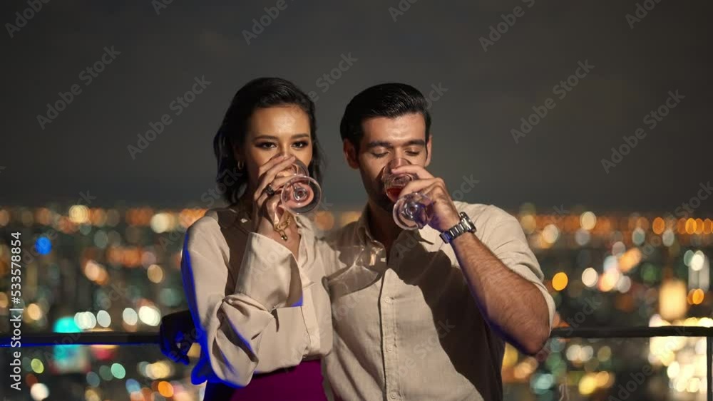 4K Caucasian couple celebrating holiday event at luxury skyscraper ...