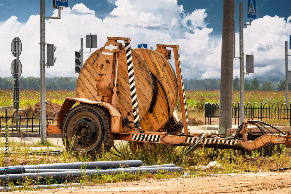 Wooden reel with high voltage cable mounted on a trailer for easy ...