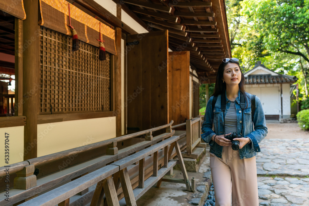 smiling asian taiwanese female visitor enjoying historic vibe and ...