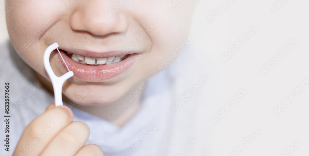 child uses plastic toothpick dental floss food remove daily care oral ...