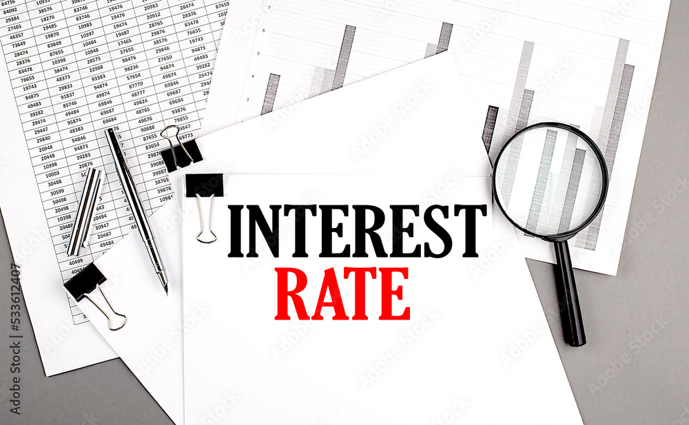 INTEREST RATE text on paper on chart background Stock Photo | Adobe Stock