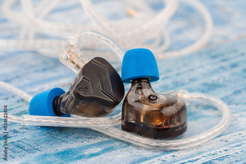 In ear monitor on a tablature background. Custom in-ear monitors with ...