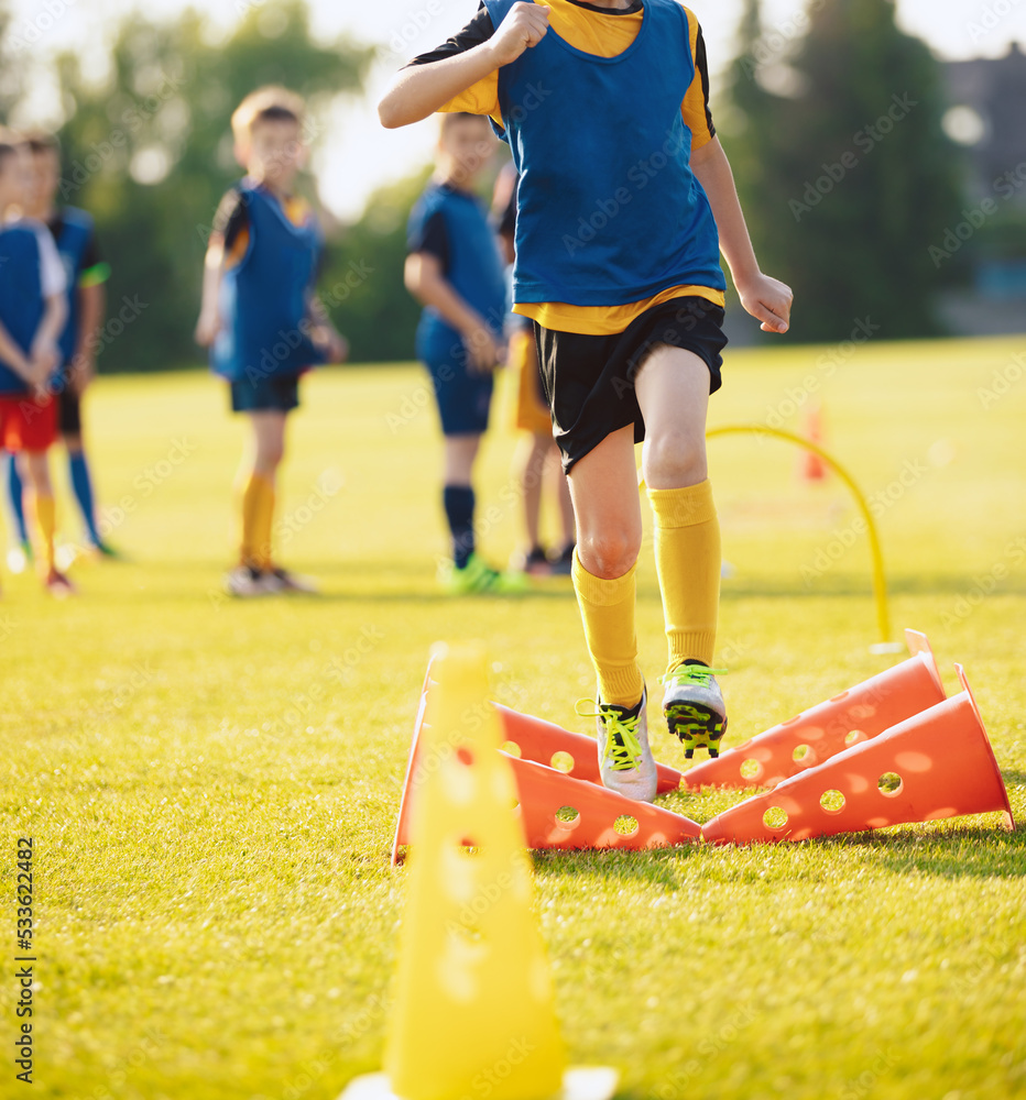School Boy Running Slalom Track Between Training Poles and Jumping Over ...
