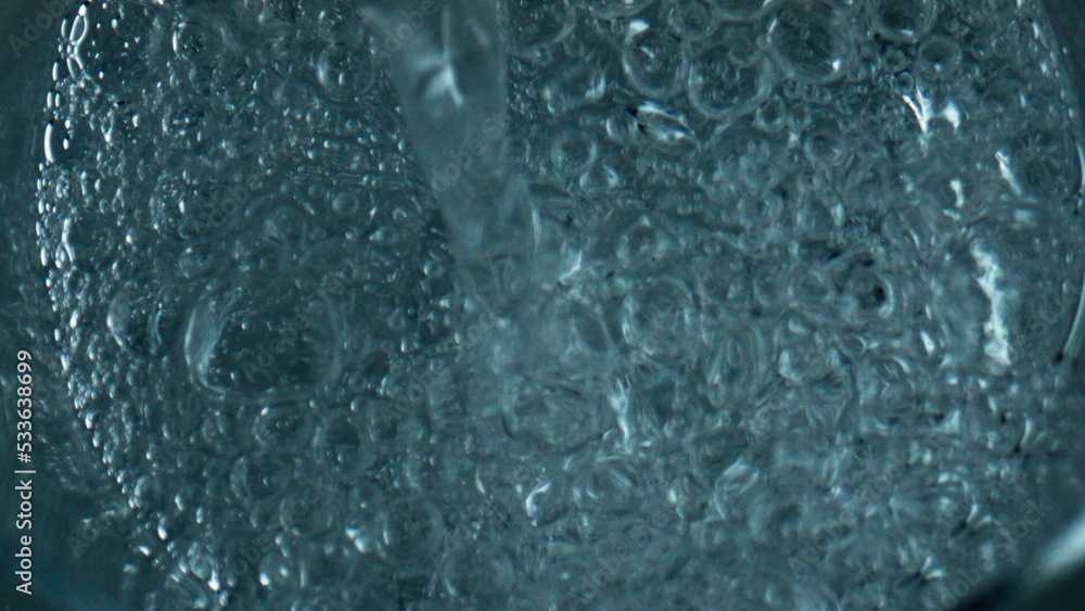 Bubbling water pouring glass top view. Closeup air bubbles rising ...