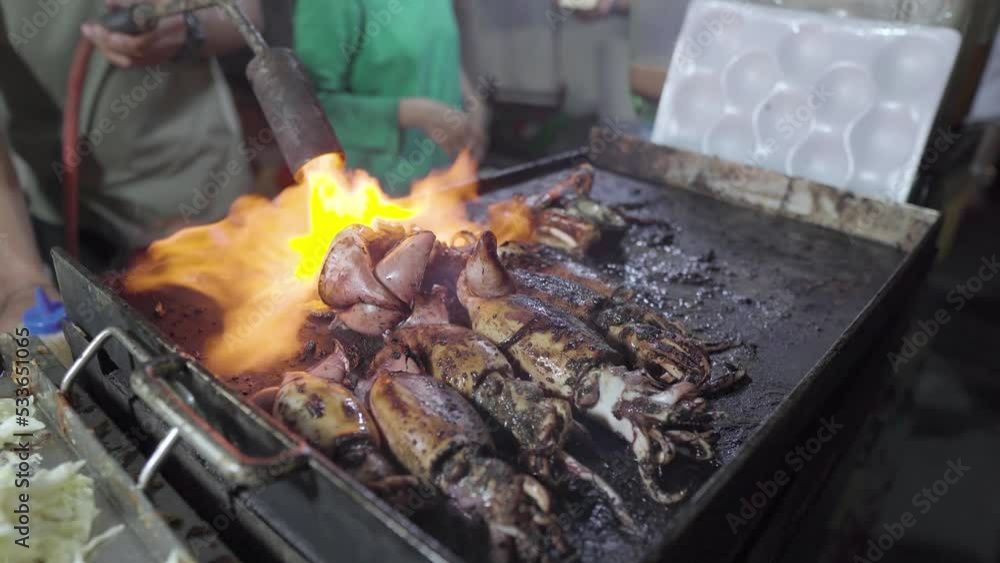 Japanese grilled squid (Ikayaki) grilled by blow torch is a street food ...