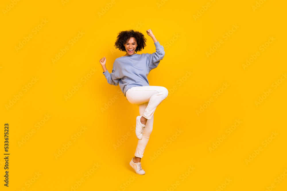 Full body portrait of overjoyed delighted girl raise fists celebrate ...