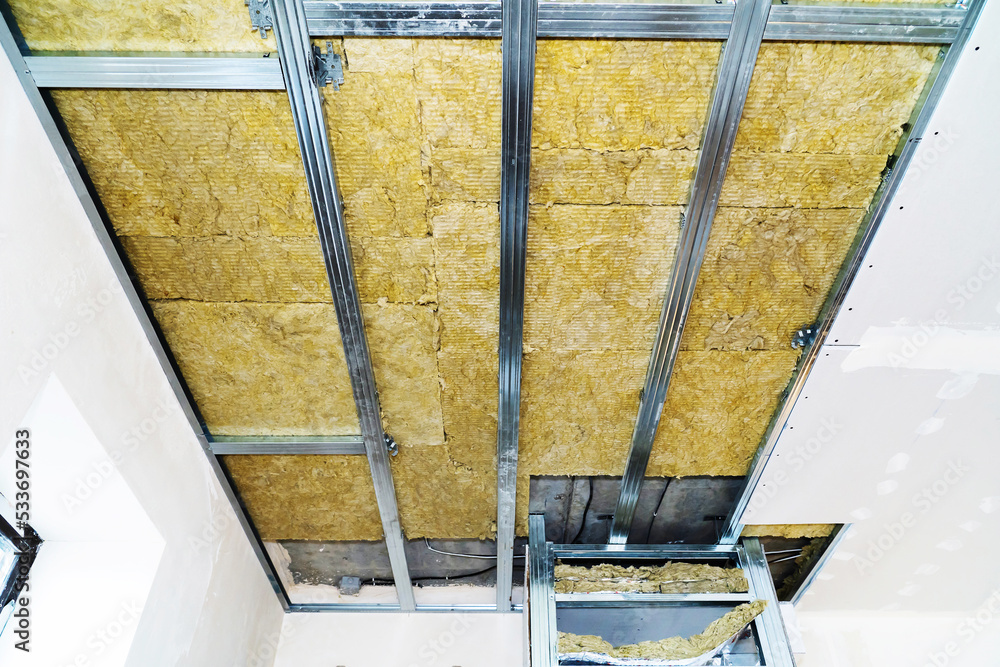 Ceiling insulation with mineral wool. Metal profile and insulation ...