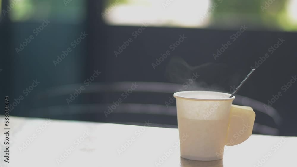 Hot water in a white paper cup And the smoke that floats out in the ...