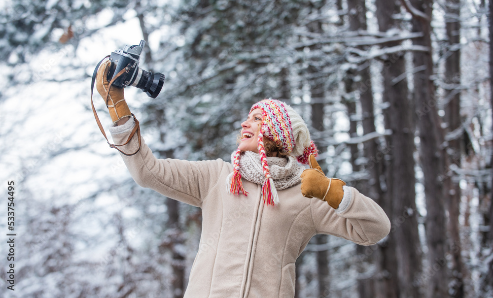 Girl with vintage camera in snowy nature. Traveling concept. Capturing ...