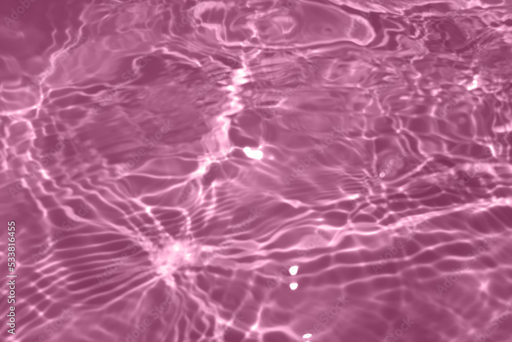 Defocus blurred transparent pink colored clear calm water surface ...