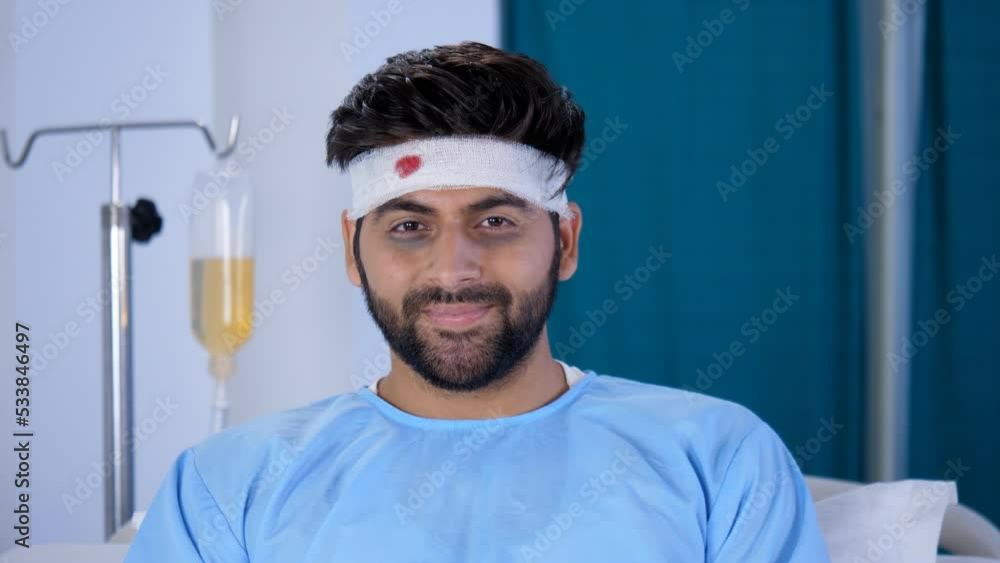 Male patient with a bandage on his head posing for the camera ...
