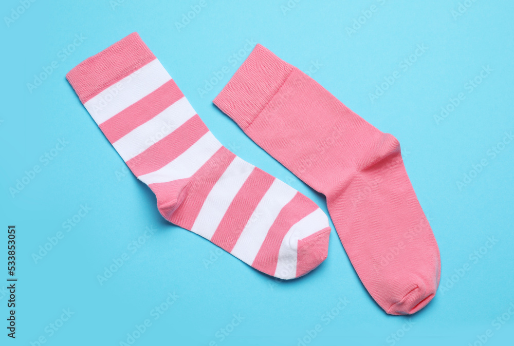 Different pink socks on light blue background, flat lay Stock Photo ...
