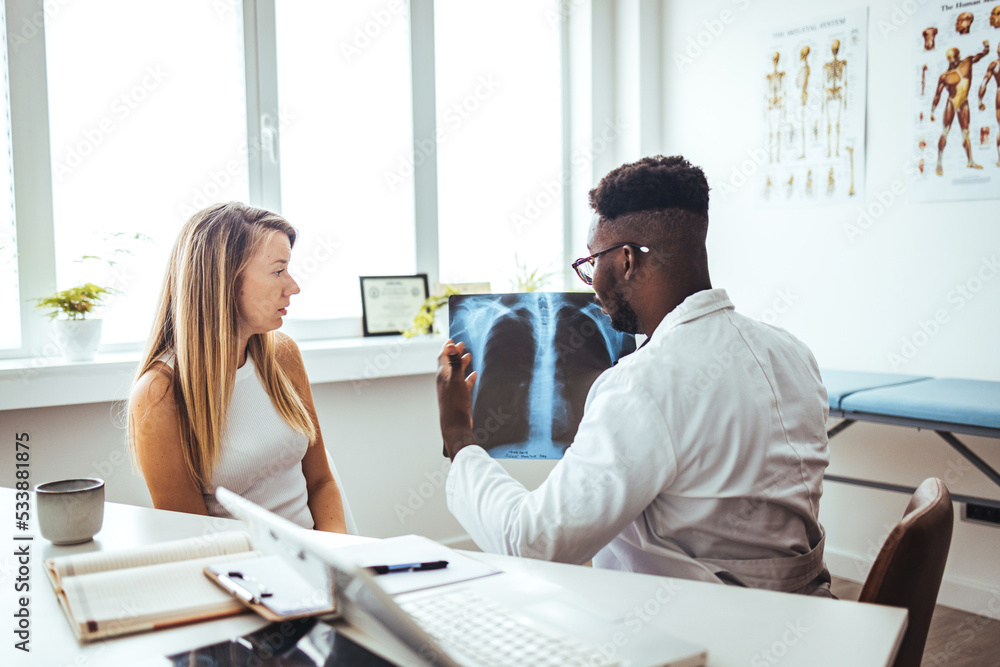 Doctor and patient discussing scan results in hospital. Doctor ...