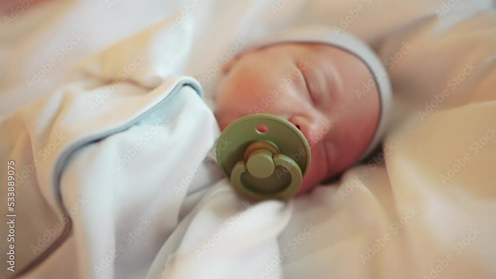 newborn baby boy sleeping with pacifier. maternity hospital happy ...