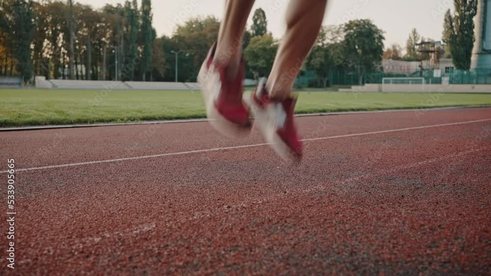 Male legs in sneakers run in place on city stadium track Stock Video ...