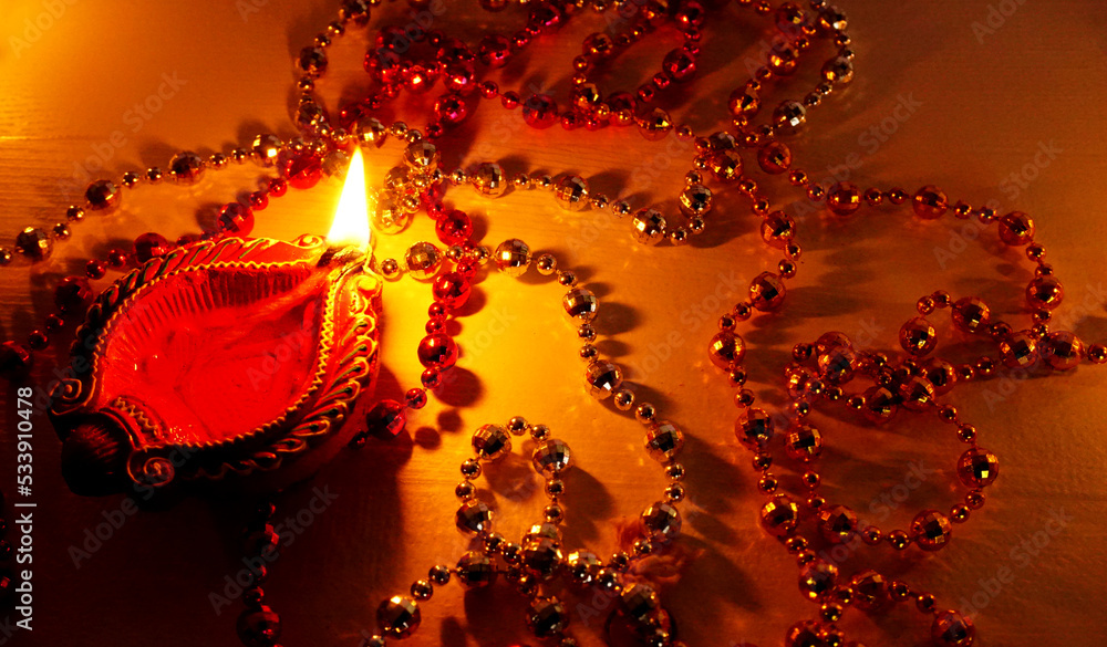 Oil lamps (Clay diya) lit on colorful rangoli during diwali celebration ...