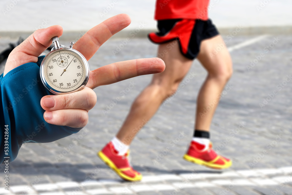 measuring the running speed of an athlete using a mechanical stopwatch ...