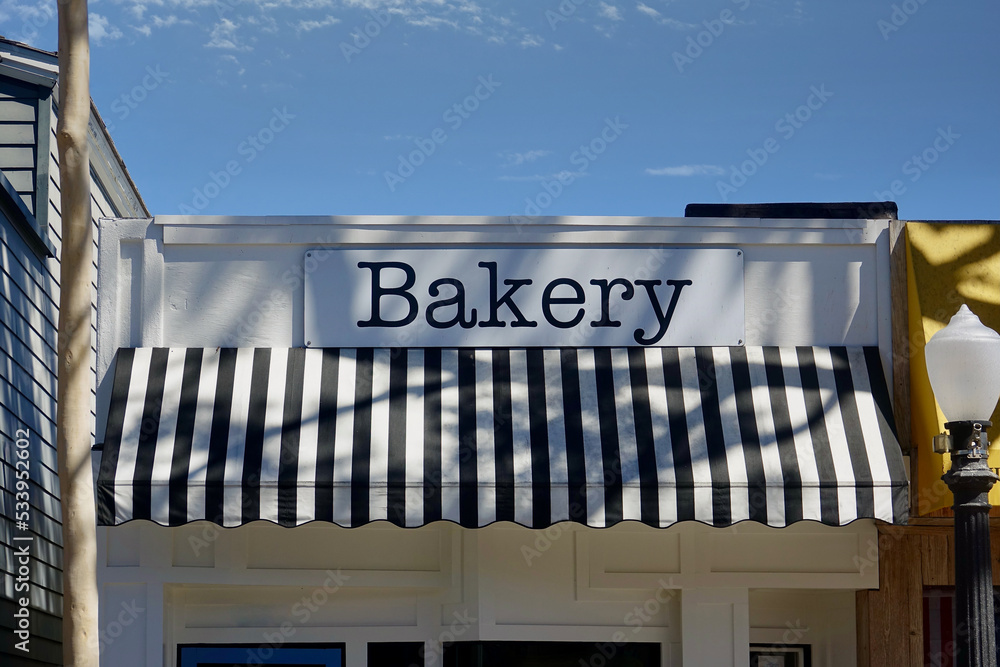 small town store front with striped awning and sign Stock Photo | Adobe ...