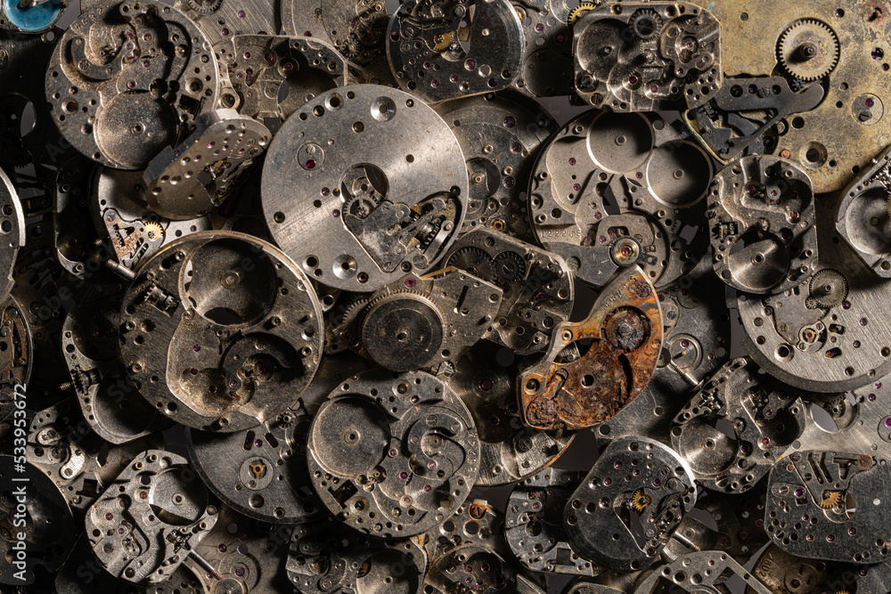Top view of heap of metal internal parts of an old clock. Silver ...