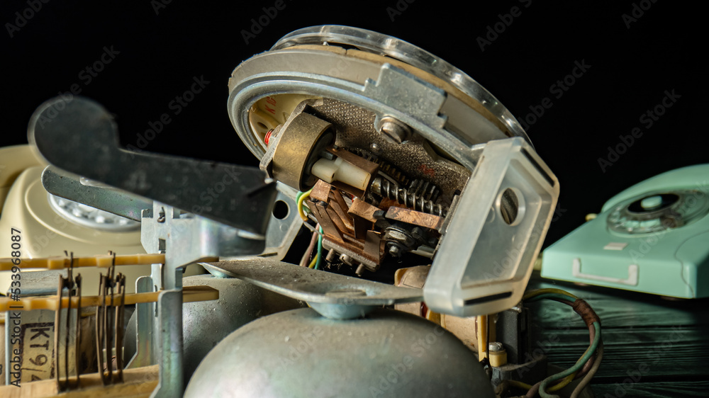 Old disassembled rotary telephone with close up of internal parts on ...